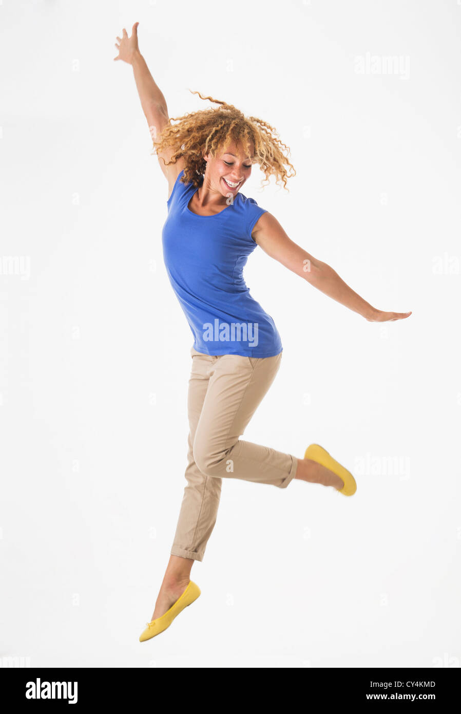 Woman jumping, studio shot Stock Photo - Alamy