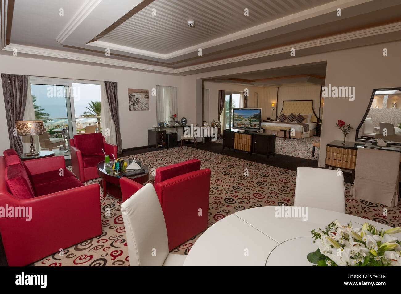 Large suite room in a luxury hotel showing the lounge and bedroom area ...