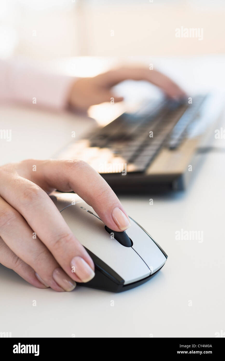 USA, New Jersey, Jersey City, Close up of woman's hands using computer ...