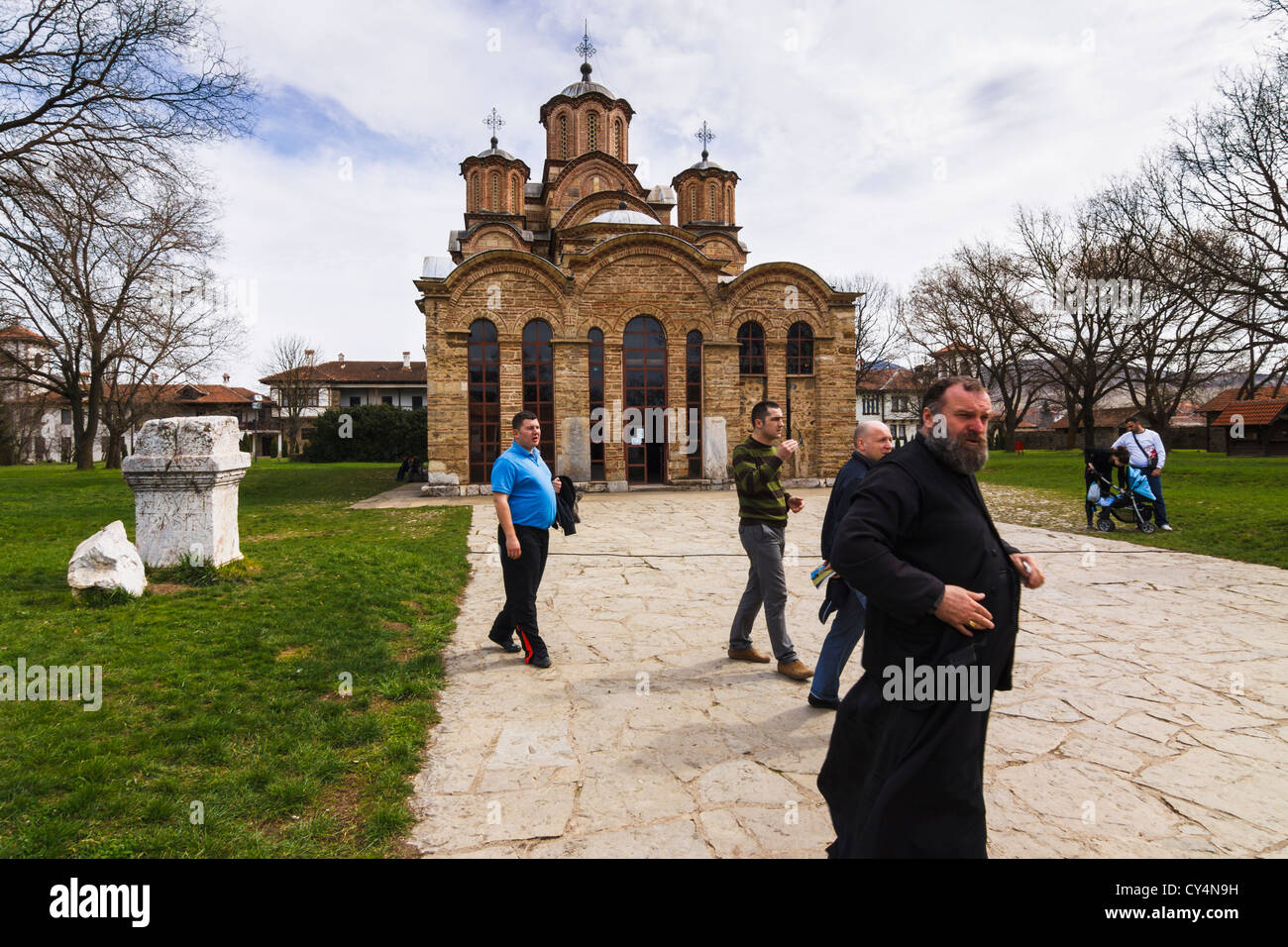 Serbian Orthodox priest and visitors at the UNESCO listed Gracanica ...