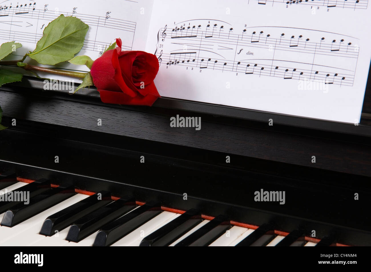 Sheet music with rose piano Stock Photo - Alamy
