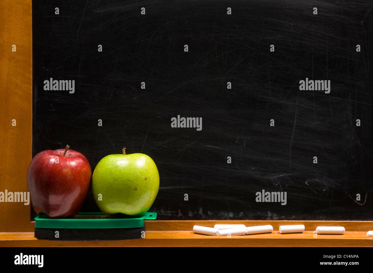 red and green apple on chalkboard ledge at school, add text to ...