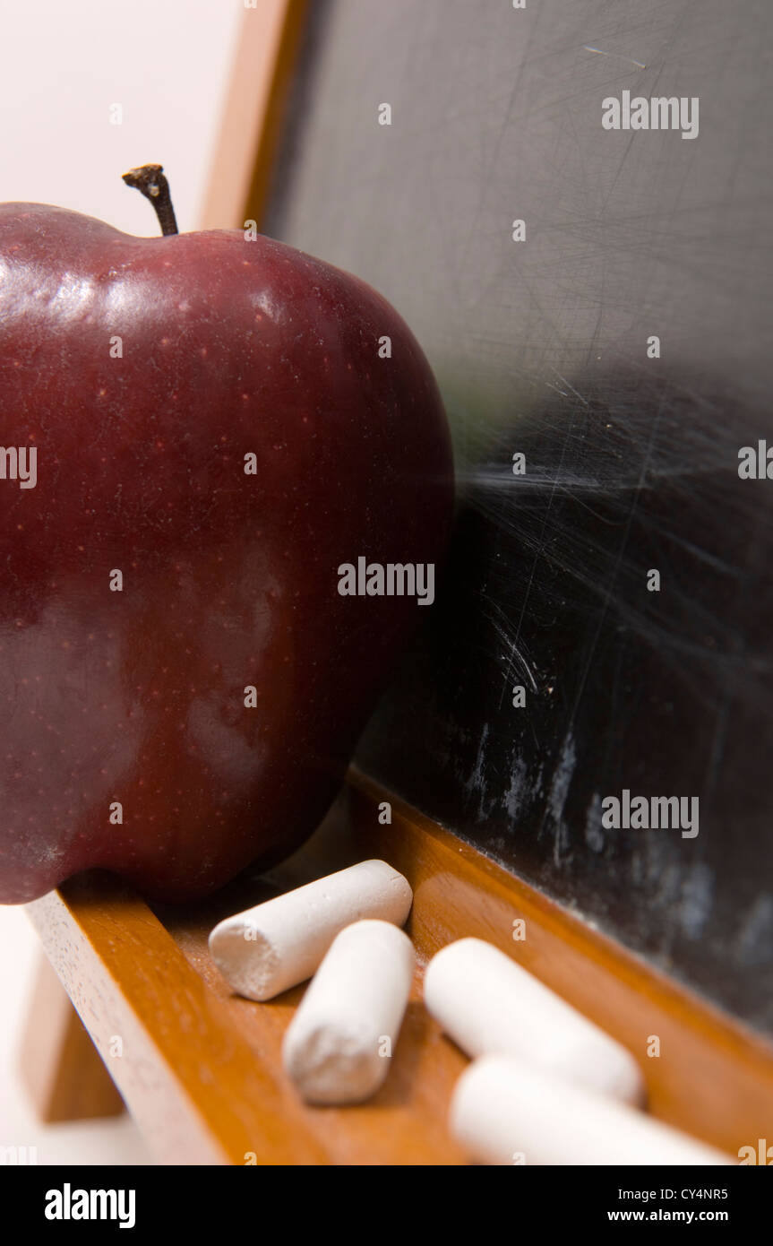 red apple on chalkboard ledge at school Stock Photo - Alamy