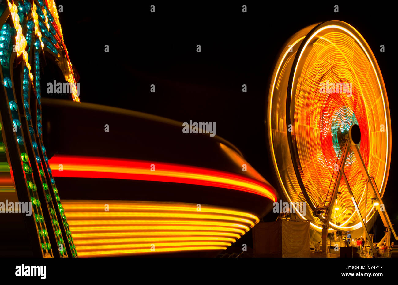 Multicolor carnival rides in motion Stock Photo - Alamy