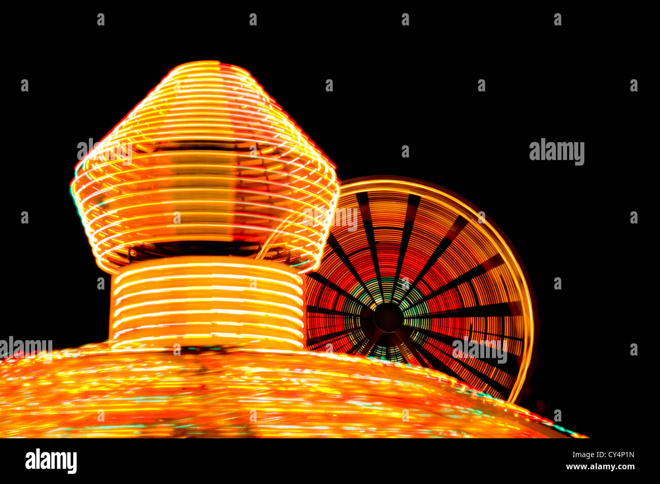 Multicolor carnival rides in motion Stock Photo - Alamy