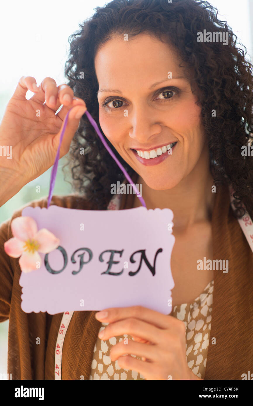 USA, New Jersey, Jersey City, Portrait of woman holding open sign Stock ...