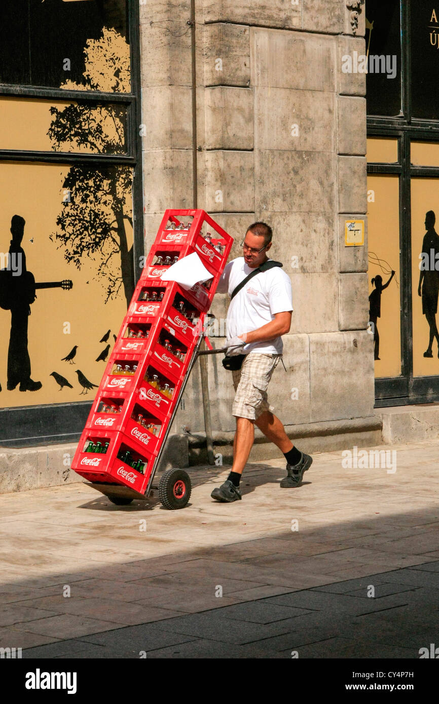 Coke delivery man wheels crates of the fizzy drink along the streets of ...