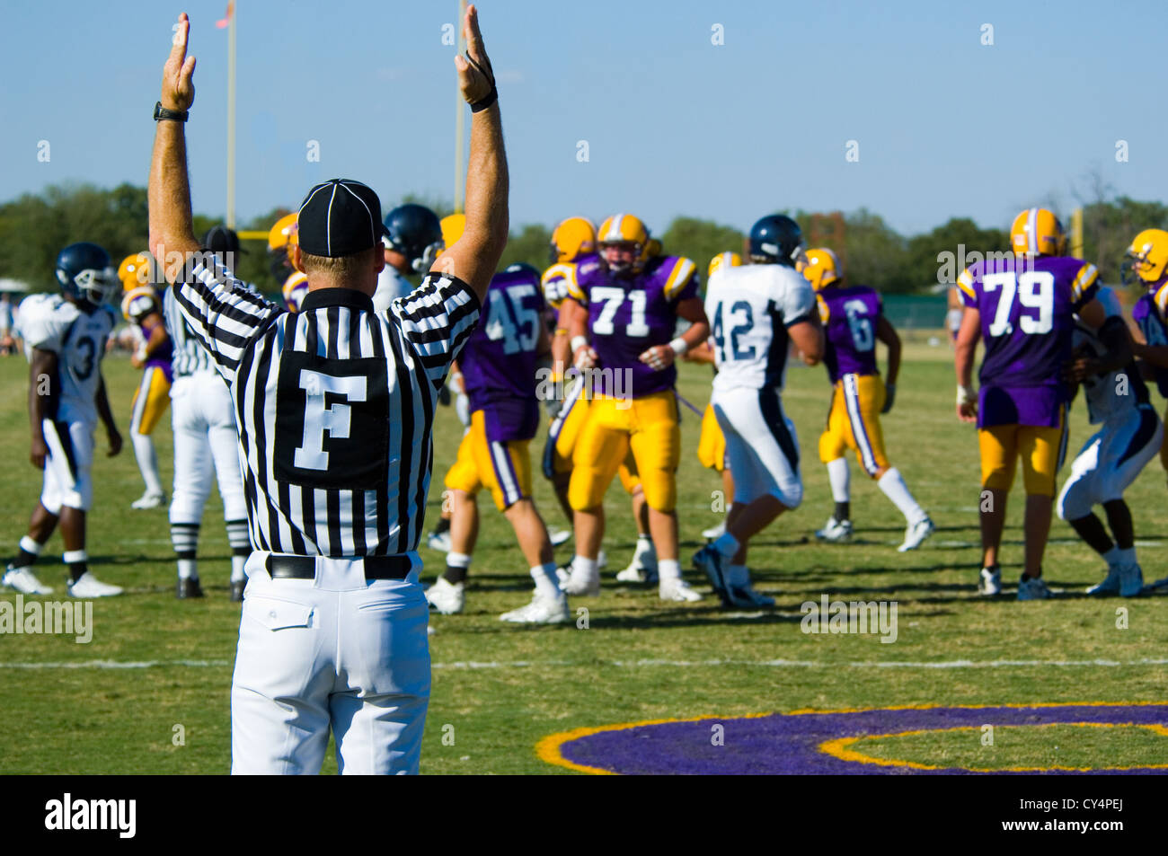 American Football played by young men scoring a touchdown signaled by ...