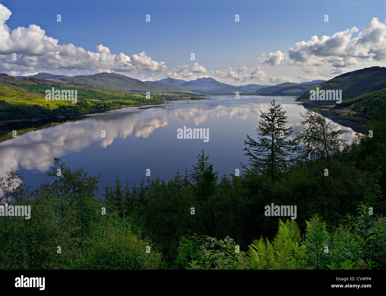 Clouds and sky reflect in a calm inlet at Loch Carron, Scottish ...