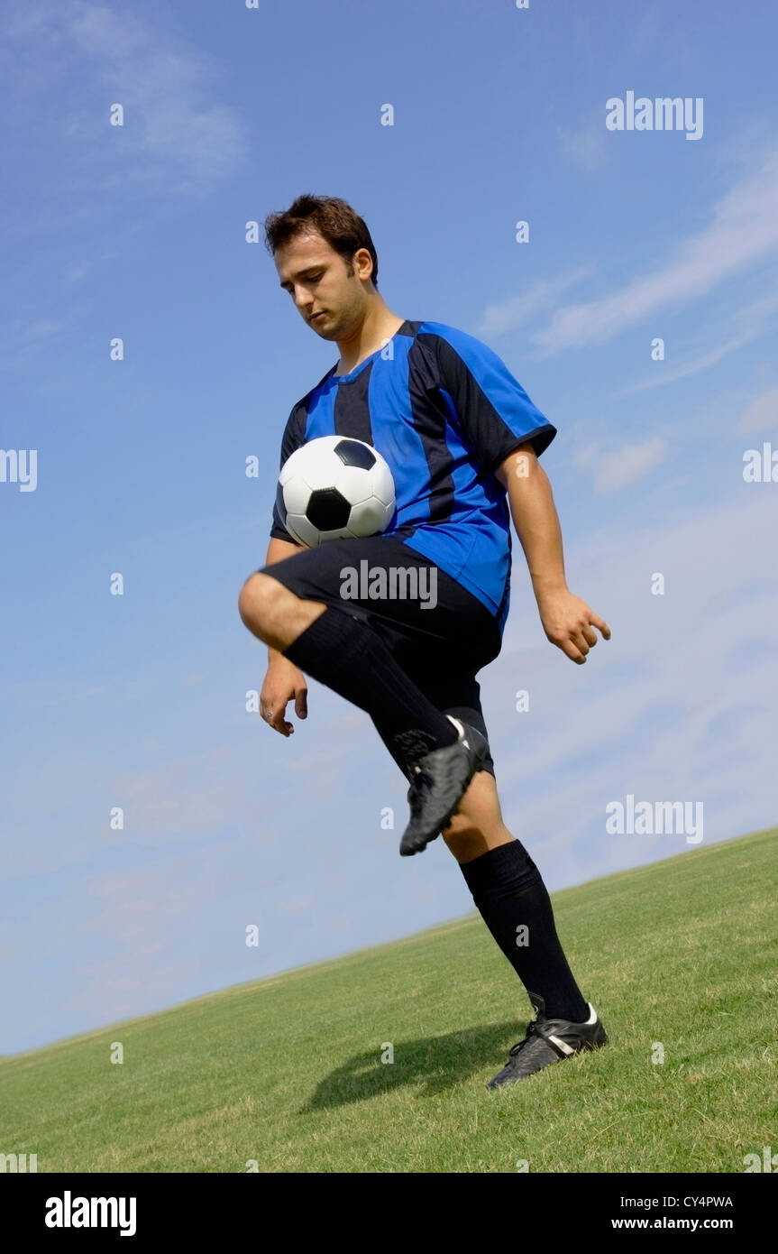 football soccer player juggling soccer ball Stock Photo - Alamy