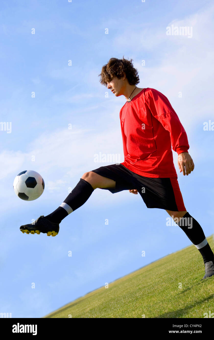 Soccer - Football Player Juggling in a Red and Black Uniform Stock ...