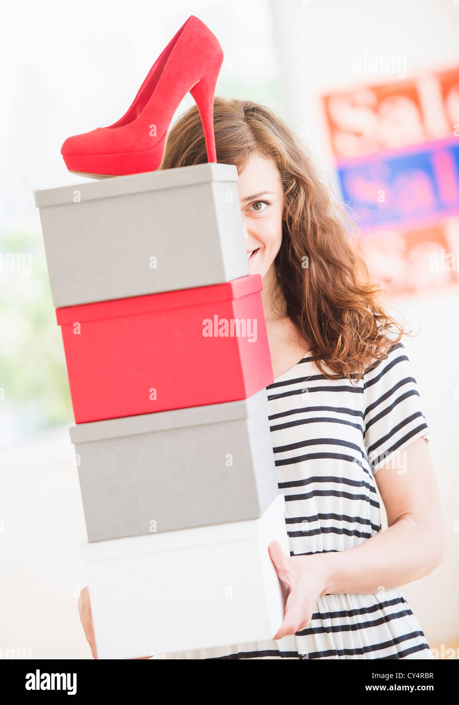 Woman carrying shoes boxes Stock Photo - Alamy