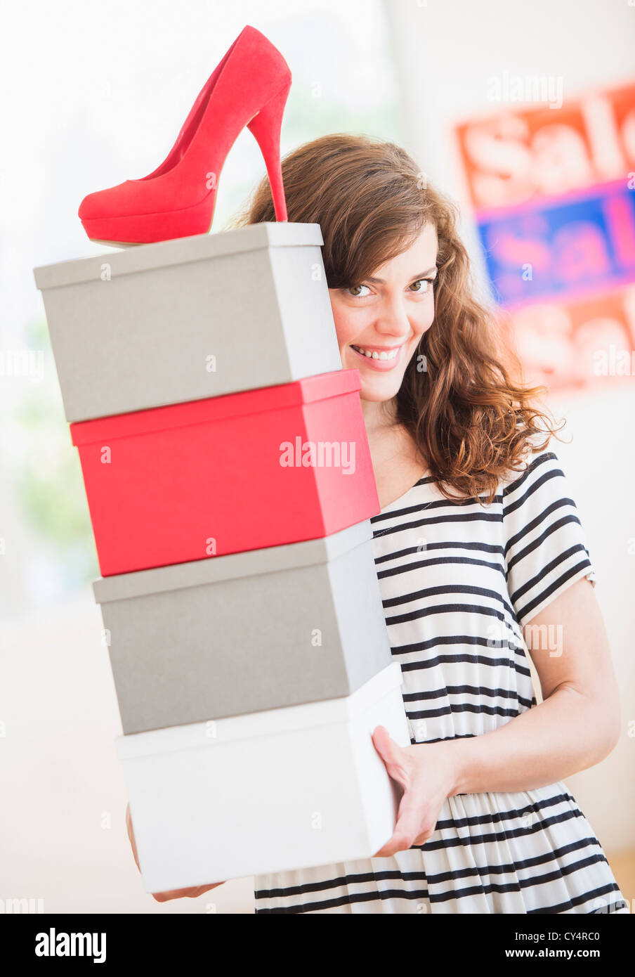 Woman carrying shoes boxes Stock Photo - Alamy