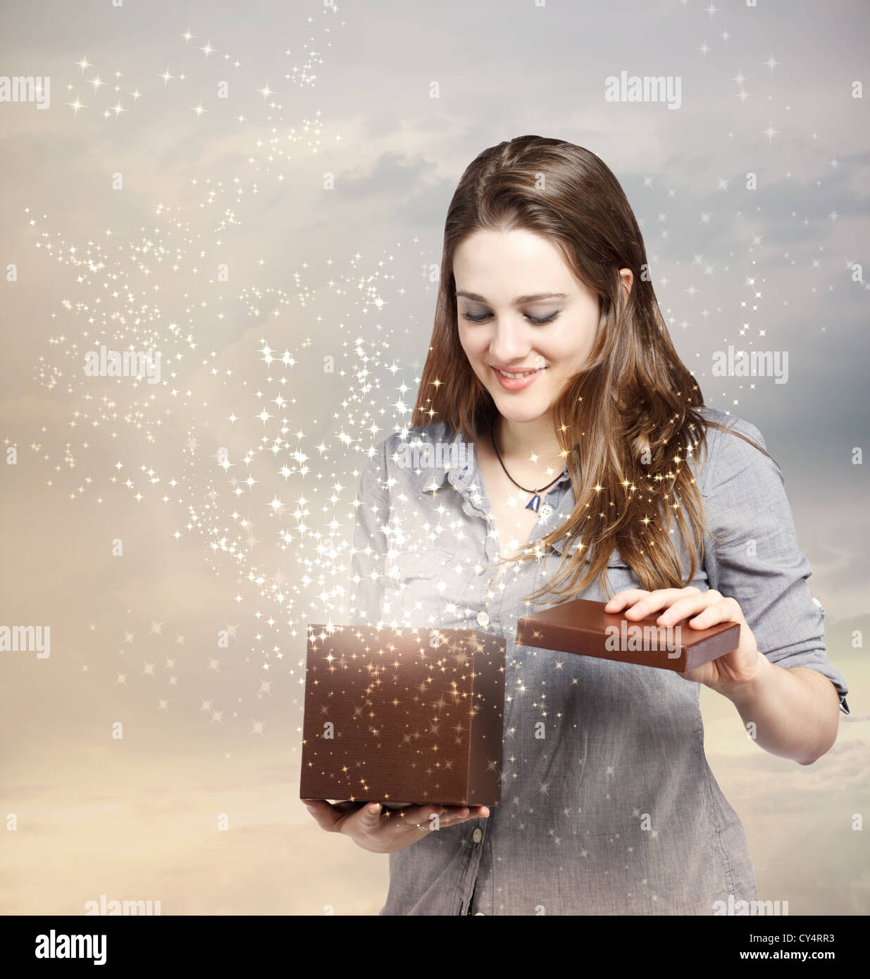 Happy Young Woman Opening a Gift Box Stock Photo - Alamy