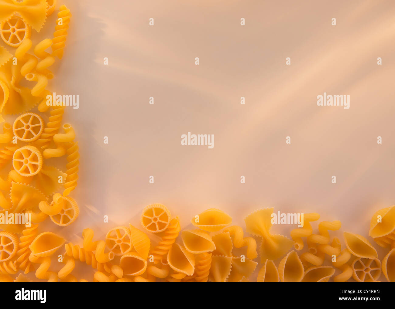 Variety of yellow pasta with blank white space in upper right corner ...