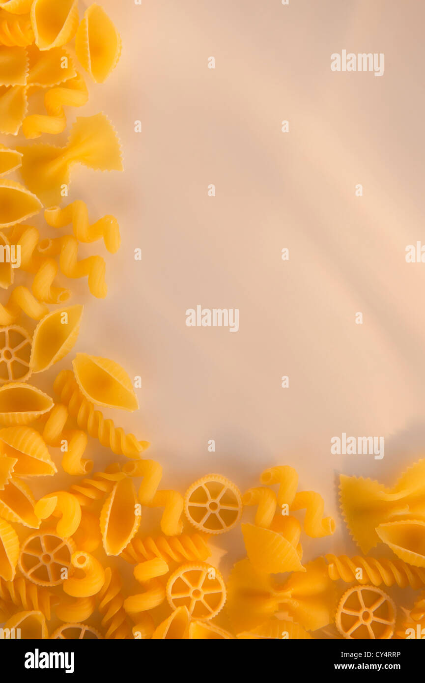 Variety of yellow pasta with blank white space in upper right corner ...