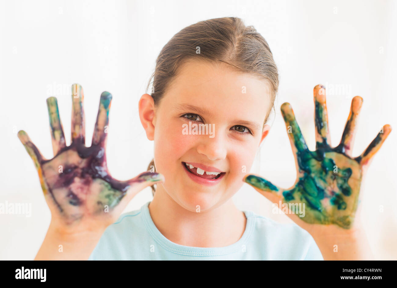 Young girl (8-9) showing hands stained with paint Stock Photo - Alamy