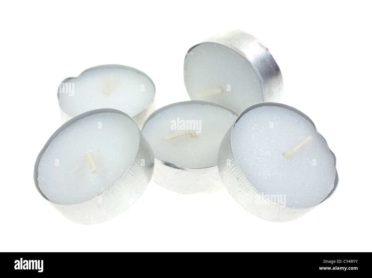 Several tea light candles on a white background Stock Photo - Alamy