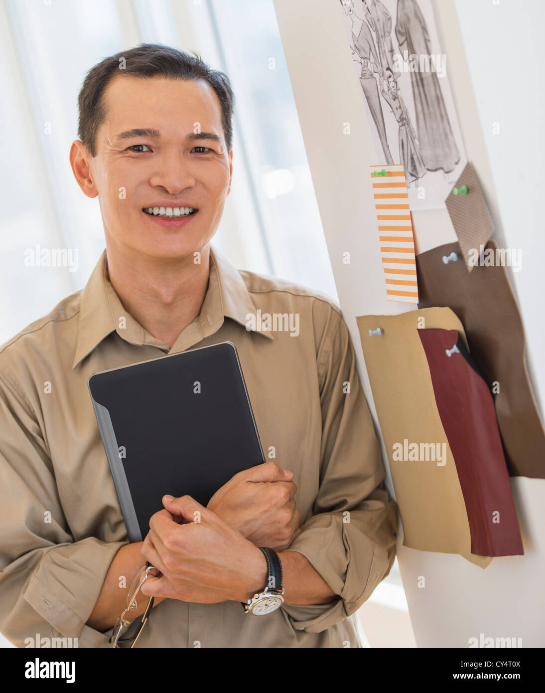 USA, New Jersey, Jersey City, Mid adult fashion designer using digital ...