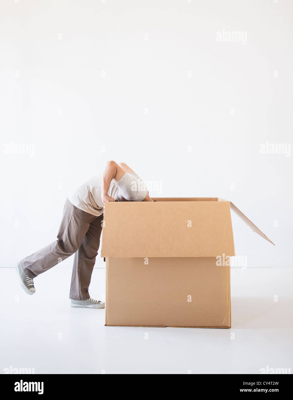 Man hiding inside cardboard box Stock Photo - Alamy