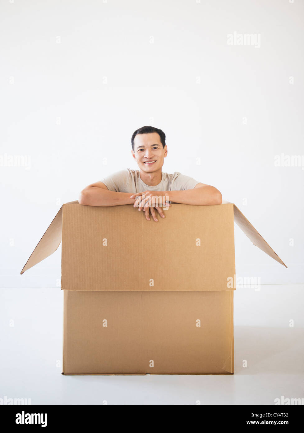 Man sitting in cardboard box Stock Photo - Alamy