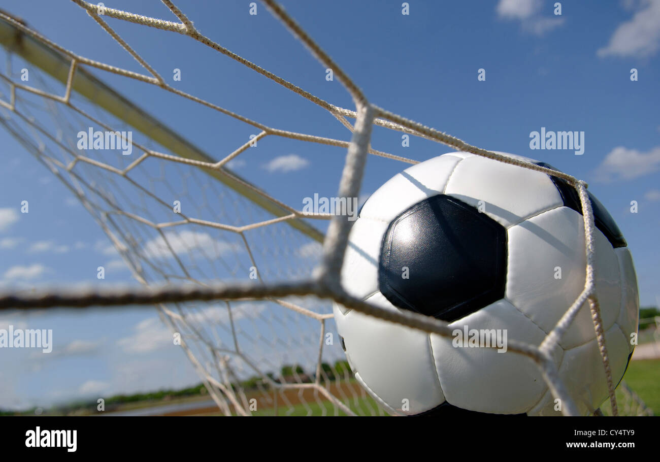 Football - soccer ball in goal against blue sky Stock Photo - Alamy