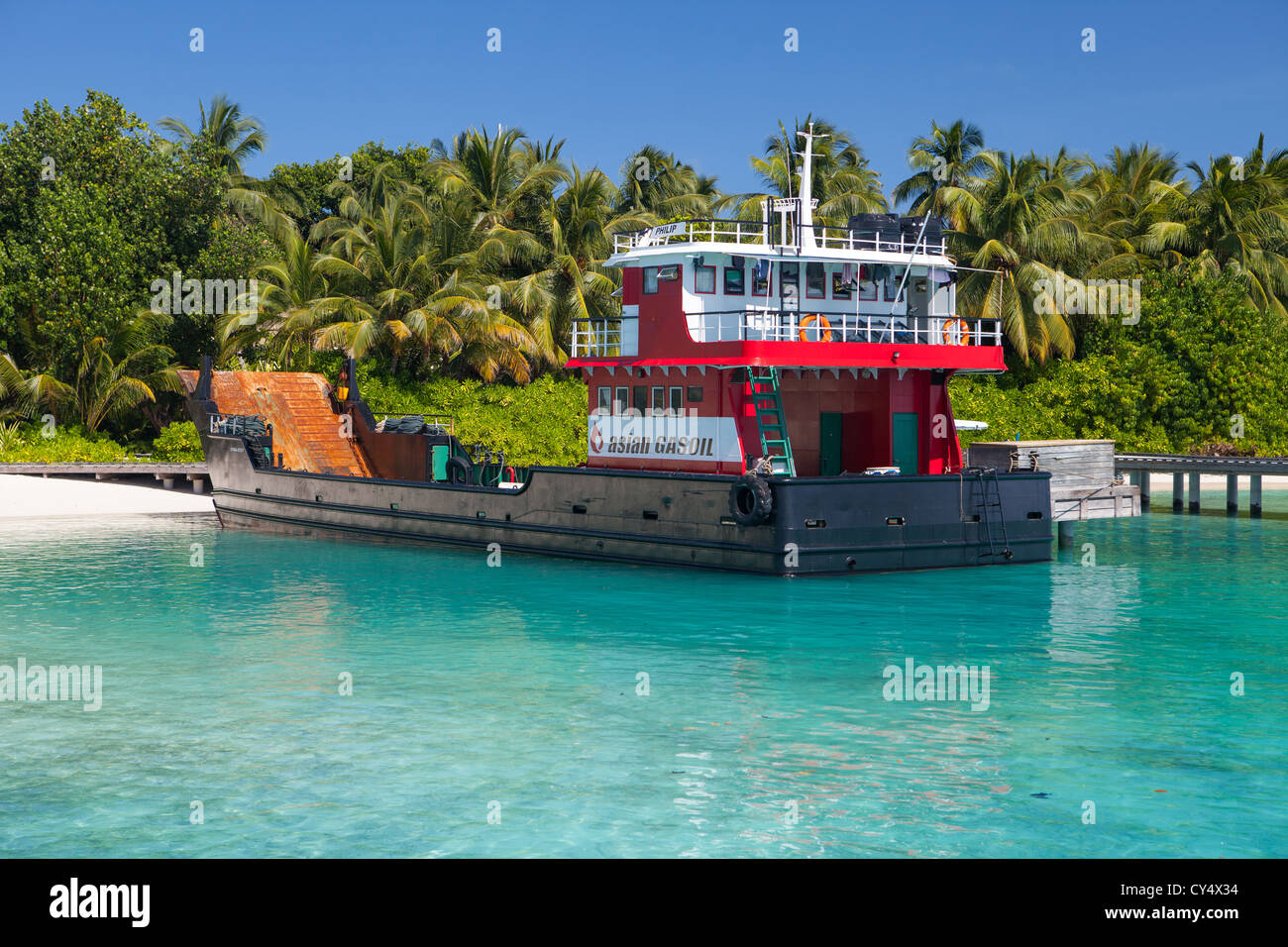 A commercial landing craft delivering plant machinery and vehicles to a ...