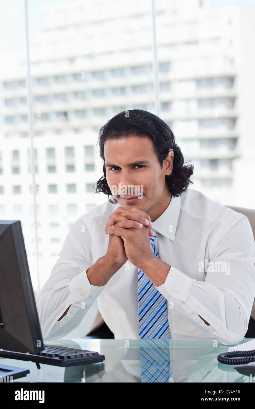 Portrait of a businessman thinking while using a monitor Stock Photo ...