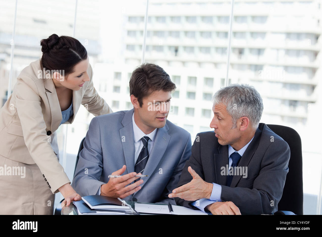 Focused business team working together Stock Photo - Alamy