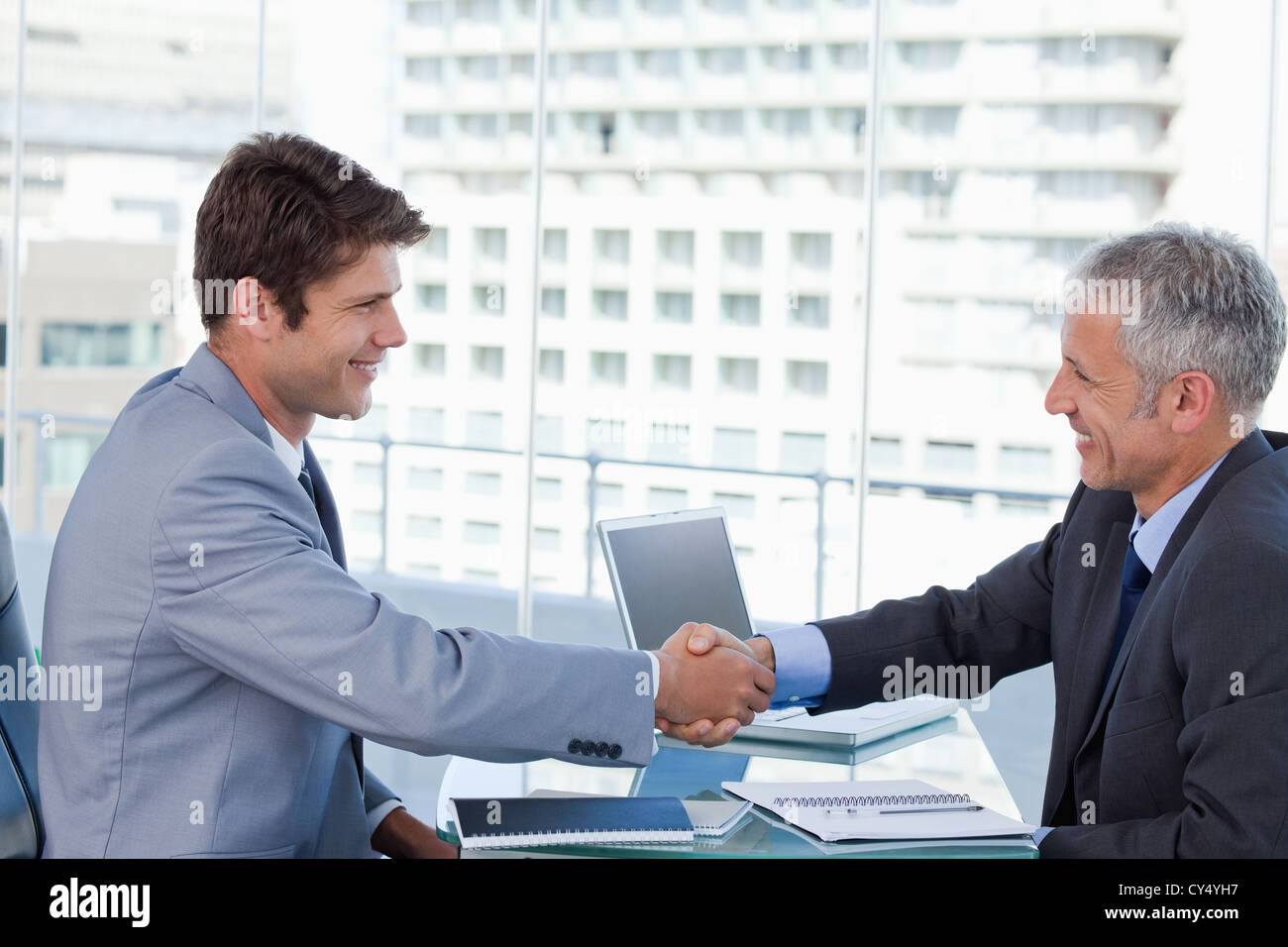 Businessmen shaking hands Stock Photo - Alamy