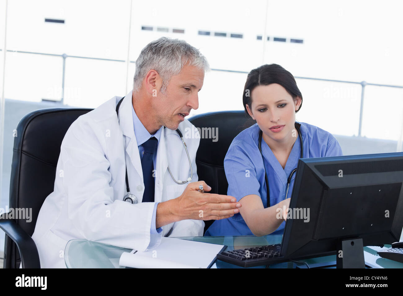 Professional medical team working with a computer Stock Photo - Alamy