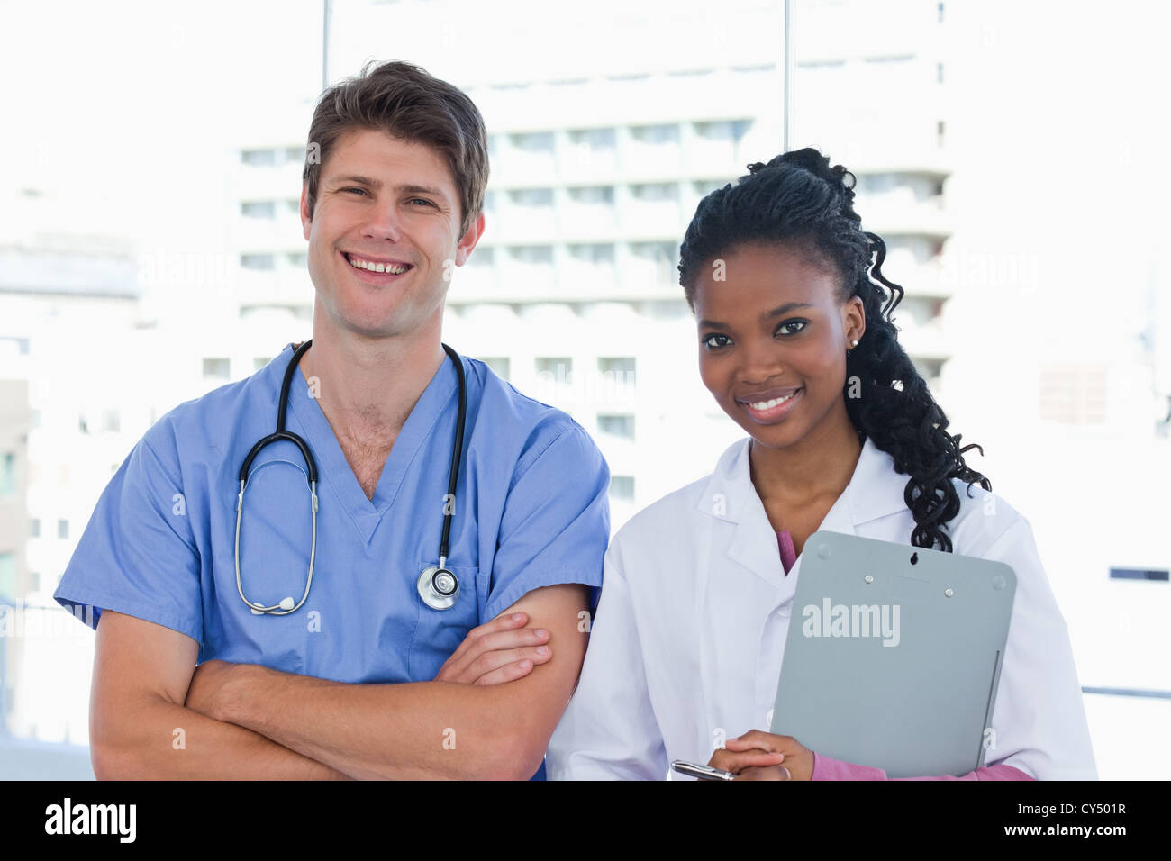 Happy doctors standing up Stock Photo - Alamy