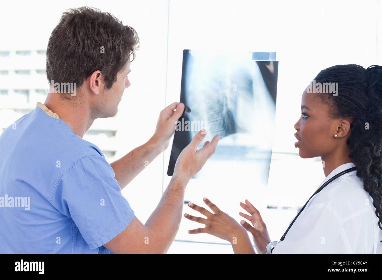 Young doctors looking at a of X-ray Stock Photo - Alamy
