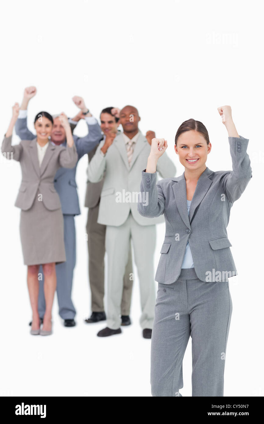 Cheering saleswoman with team behind her Stock Photo - Alamy