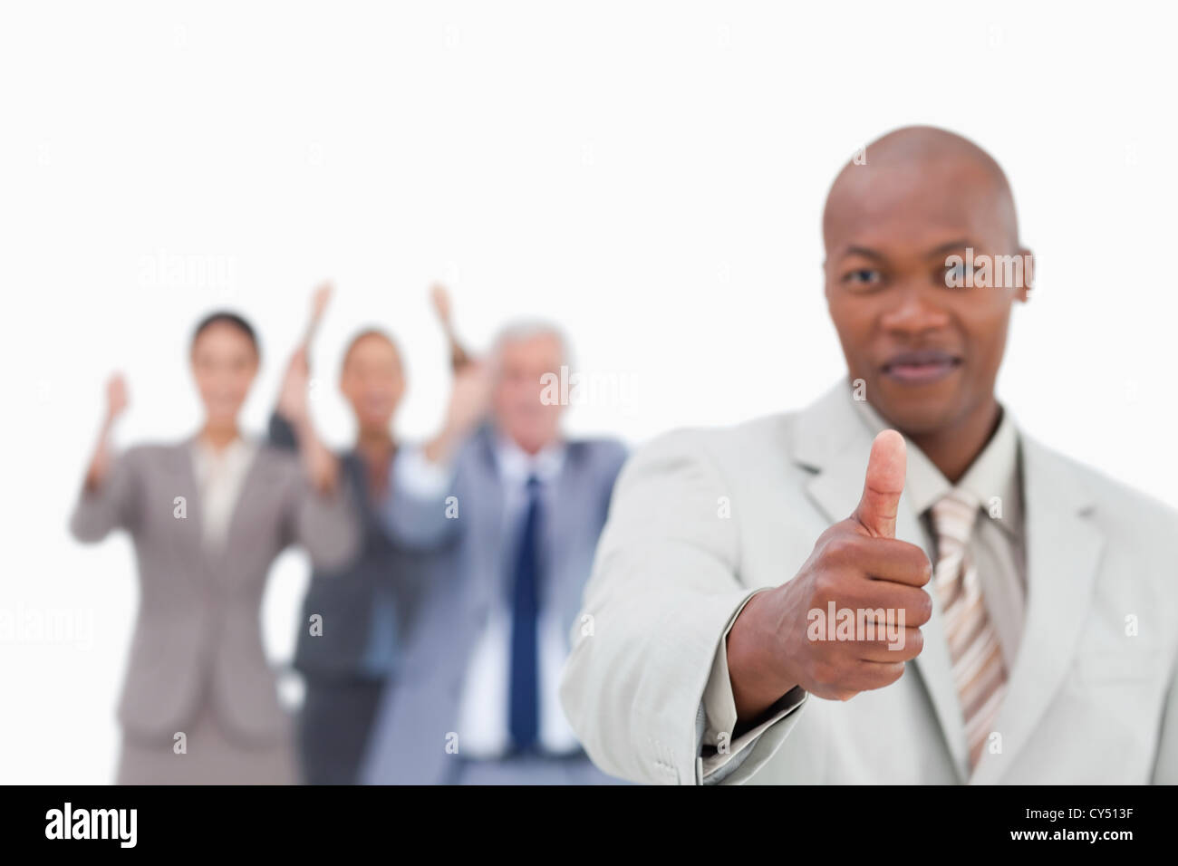 Salesman with team behind him giving approval Stock Photo - Alamy