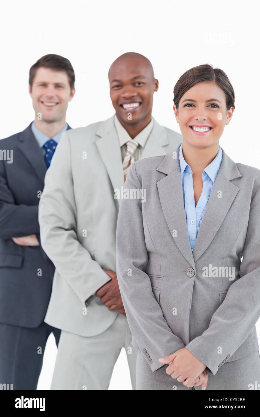Smiling sales team standing together Stock Photo - Alamy
