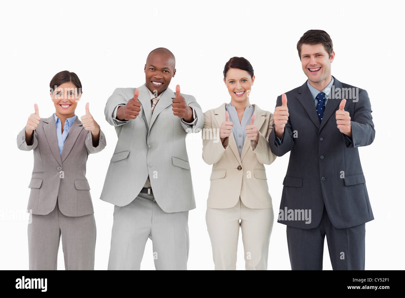 Smiling sales team giving thumbs up Stock Photo - Alamy
