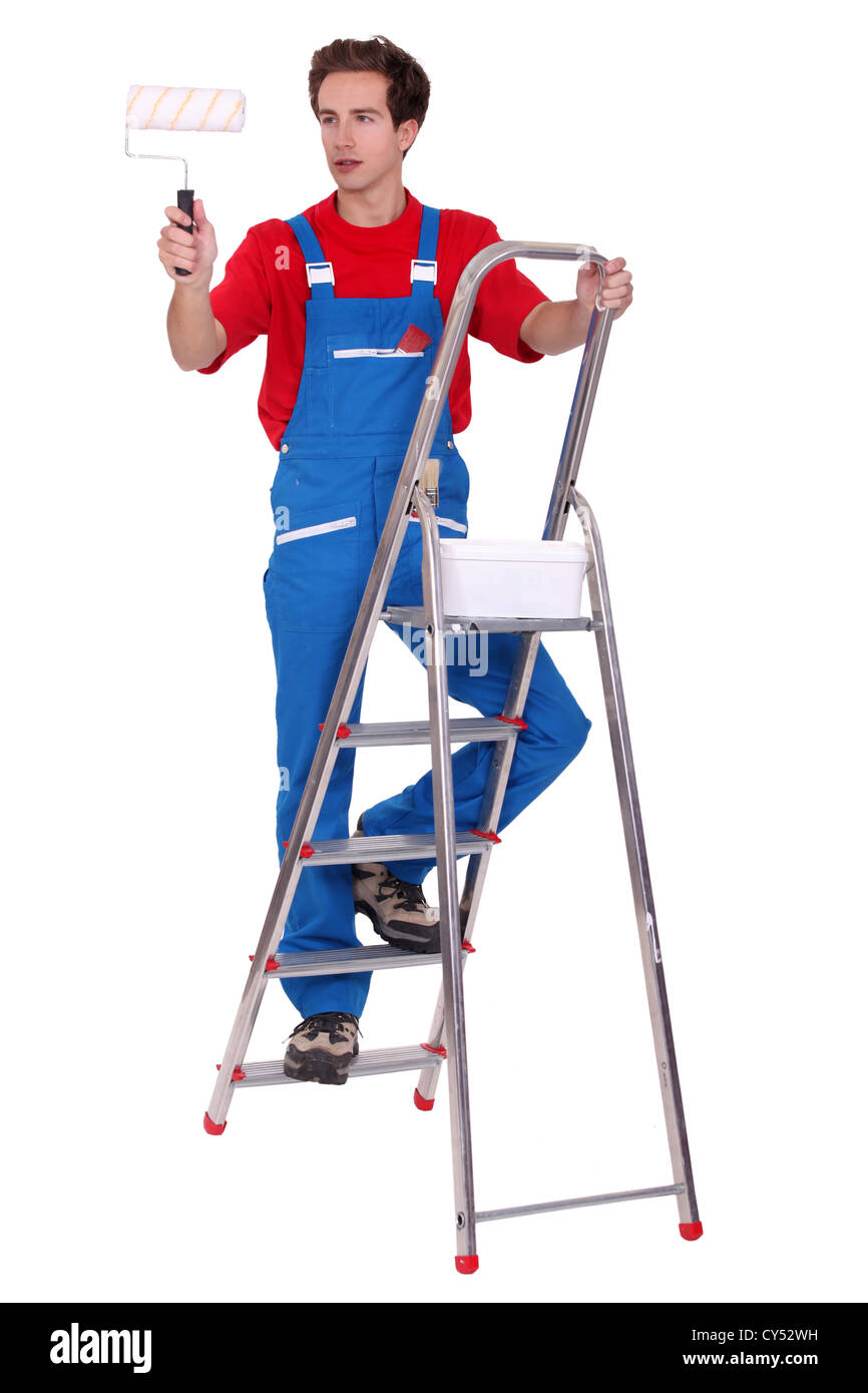 Painter painting whilst up ladder Stock Photo - Alamy