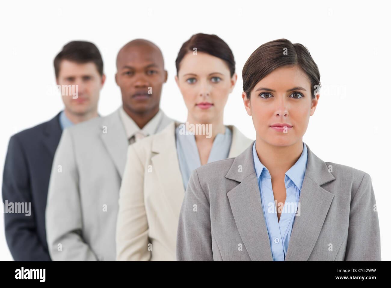 Serious looking sales team standing together Stock Photo - Alamy