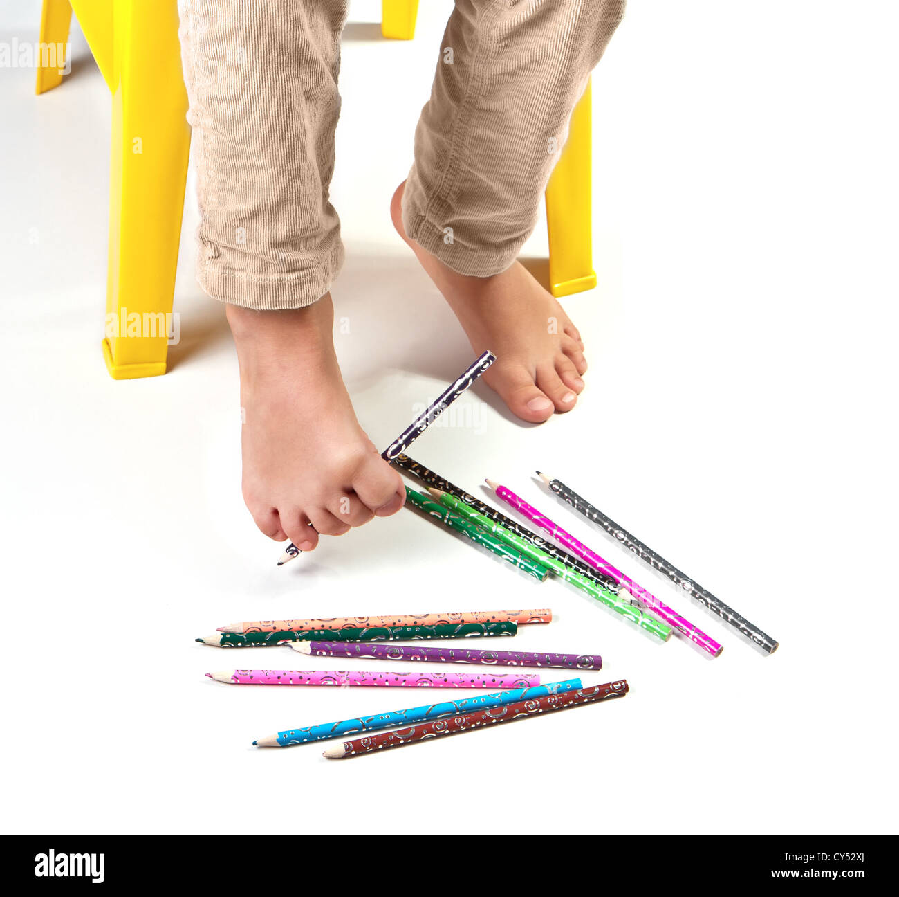 Child's feet performing gymnastic with pencils Stock Photo - Alamy
