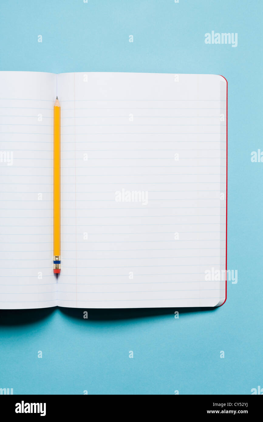 Single yellow sharpened pencil with blank composition notebook Stock ...