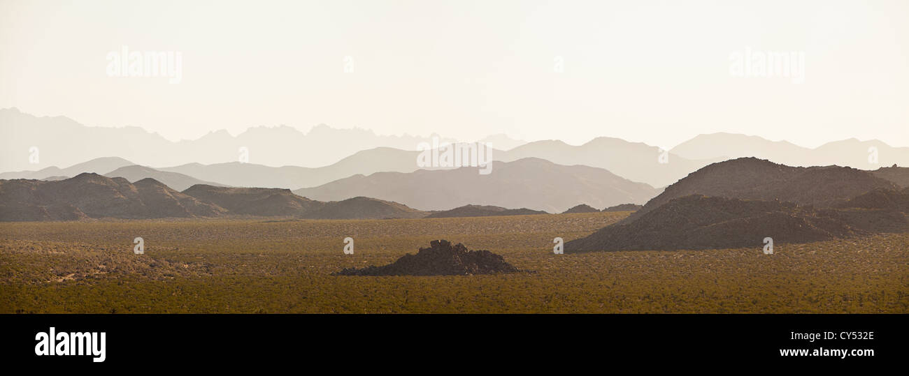 Several mountain ranges backlit by morning sun Stock Photo - Alamy