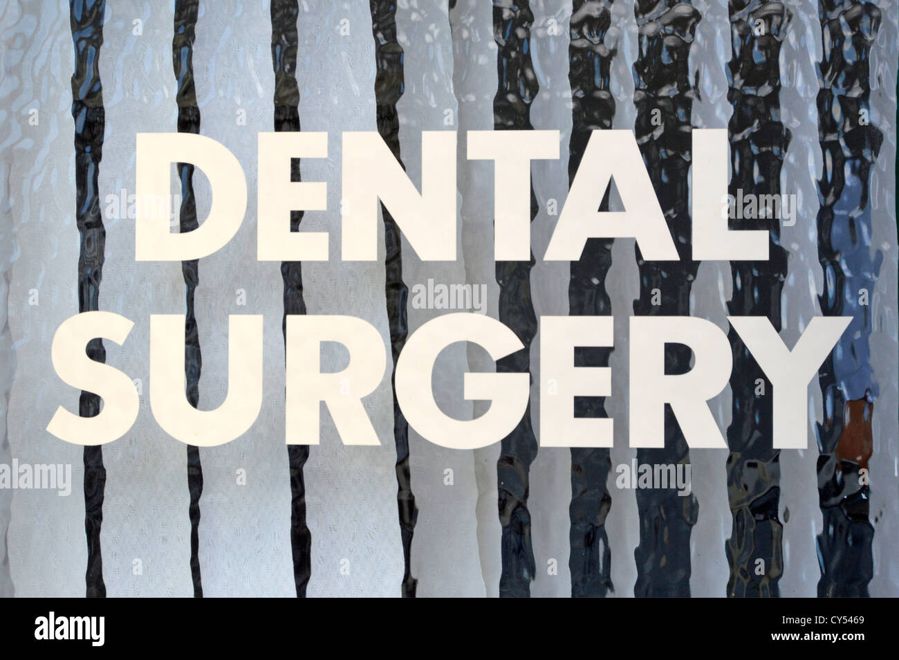 Close Up On Crinkly Obscured Glass Window Of A Sign For Dental Surgery Close Up On Crinkly Obscured Glass Window Of A Sign For Dental Surgery