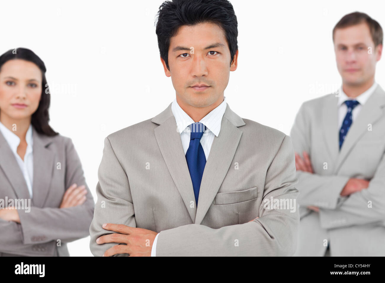 Confident sales team with arms folded Stock Photo - Alamy