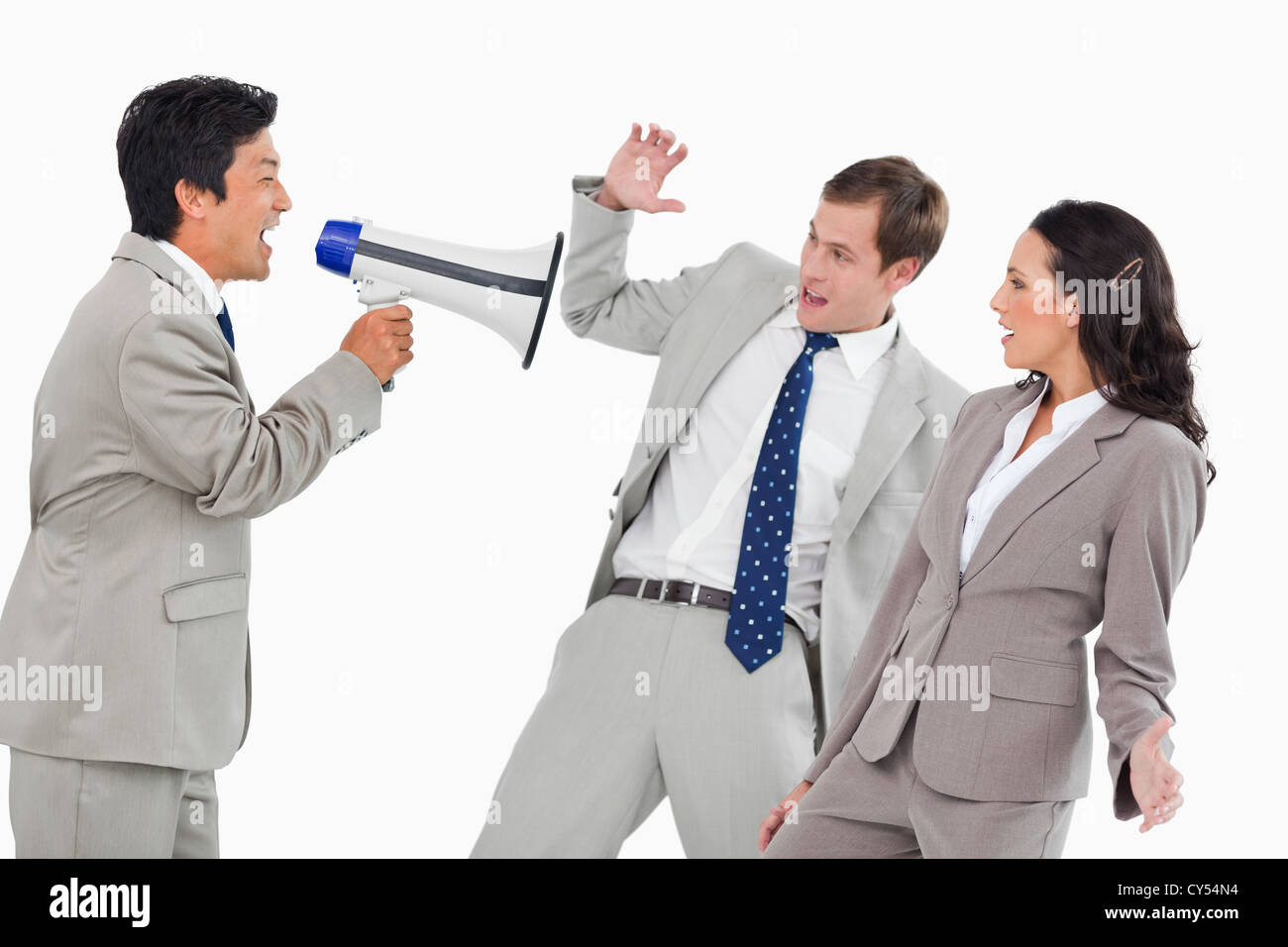 Businessman with megaphone yelling at colleagues Stock Photo - Alamy
