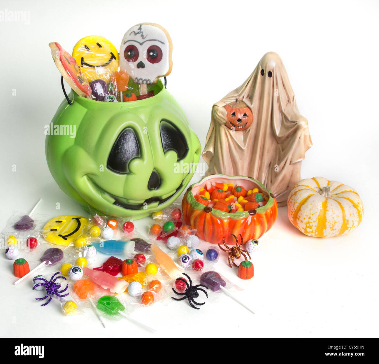 Green pumpkin Halloween bucket filled with candy, candy corn, suckers ...