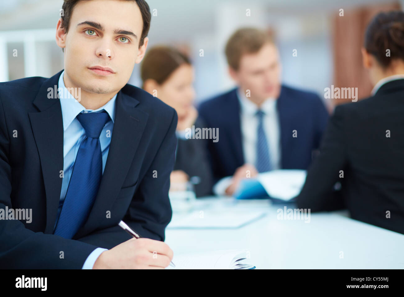 Portrait of attractive pensive male in working environment Stock Photo ...