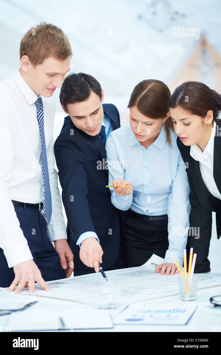 Team of engineers discussing blueprint at meeting Stock Photo - Alamy