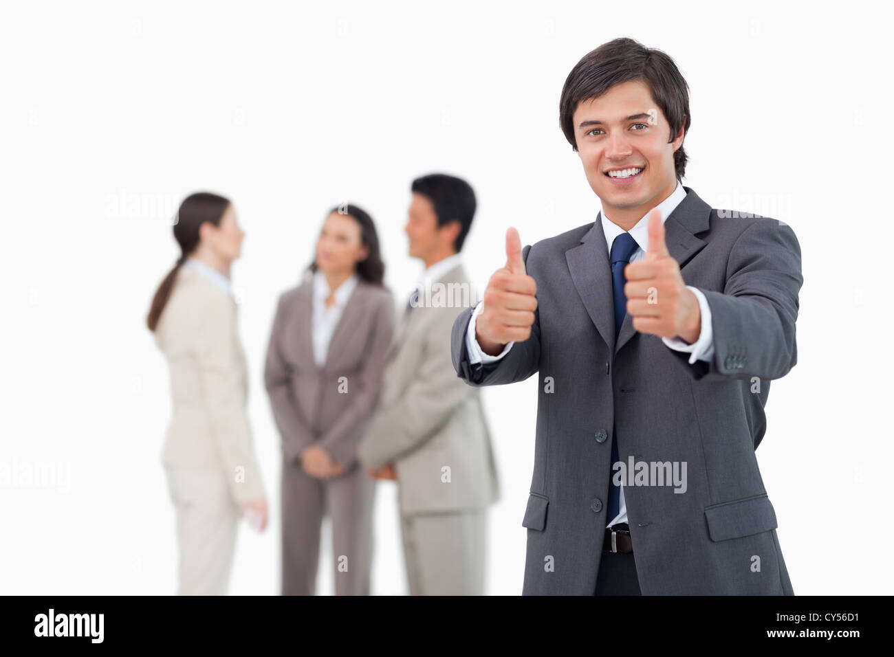 Salesman giving his approval with team behind him Stock Photo - Alamy