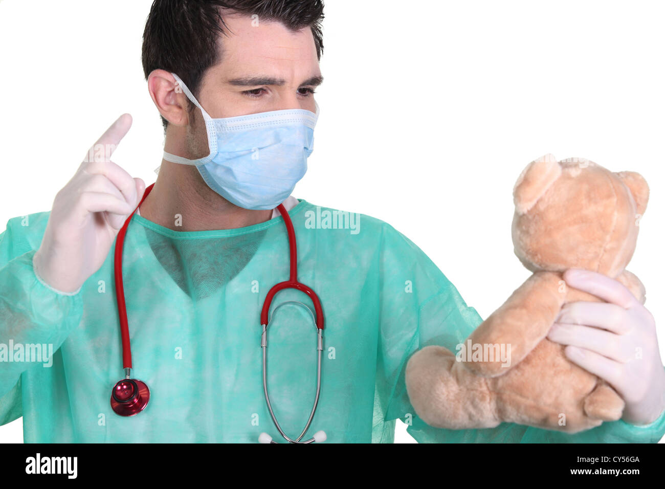 Man dressed as a surgeon quarrelling with teddy bear Stock Photo - Alamy